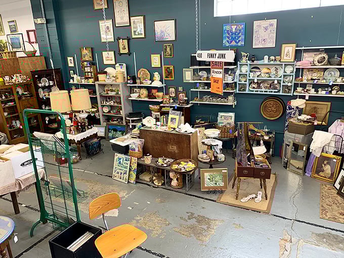 The "Funky Junk" corner—where one person's castoffs become another's conversation pieces. That blue wall makes everything pop like a vintage magazine spread.