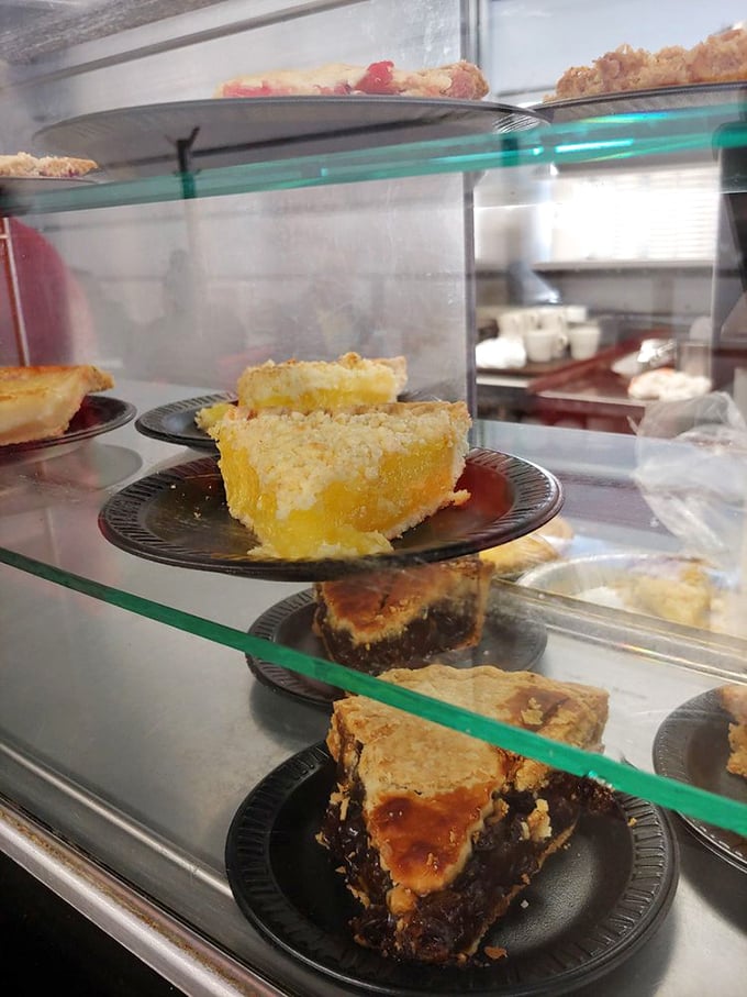 The pie case at Kewpee is like a museum of American dessert excellence, each slice a masterpiece of fruit, sugar, and buttery crust.