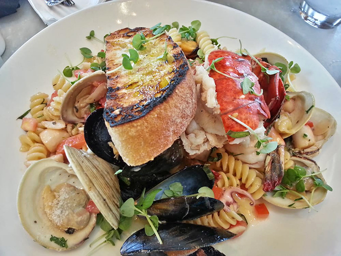 Pasta that's gone swimming with the right crowd—mussels, clams, and what appears to be lobster having a party on your plate.