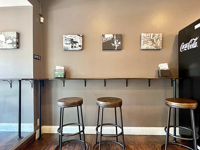 A minimalist seating area that says, "Don't get comfortable—there's a line outside." Simple stools, clean counters, and black-and-white photos that hint at Philadelphia's rich food history.