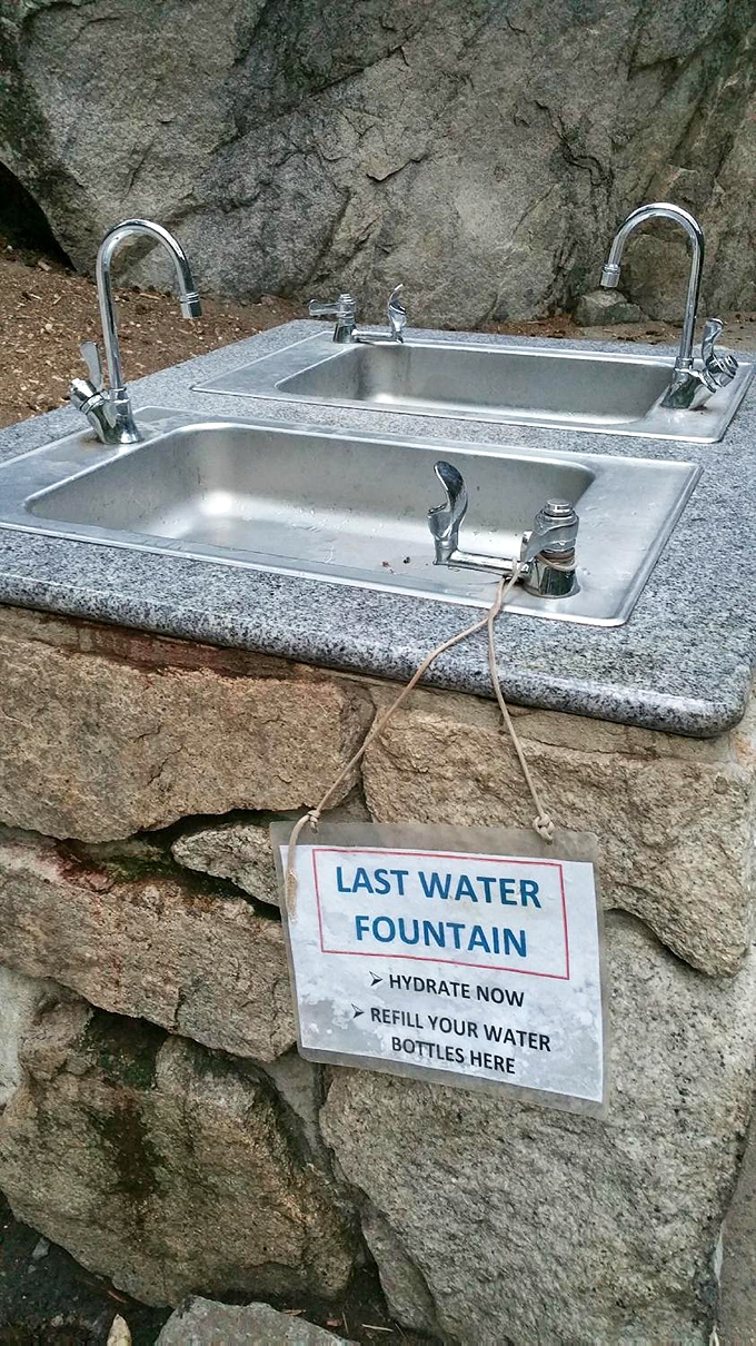 The "Last Water Fountain" sign might as well read "Hydrate or Die." Nature doesn't offer refill stations on those 600 steps ahead.