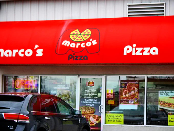 Red awning alert - pizza goodness ahead! Marco's bright signage is like a beacon for hungry travelers.