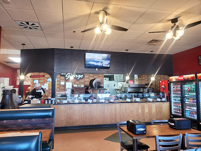 Pizza by George's burgundy walls and cozy booths create the perfect backdrop for pizza that's worth crossing town (or counties) for!