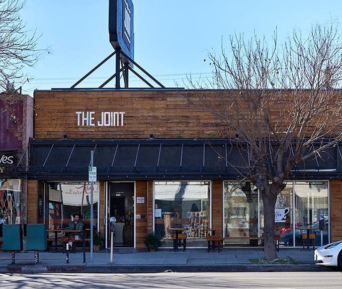 The Joint's wooden facade and simple signage – where coffee meets seafood in a union that somehow makes perfect sense.