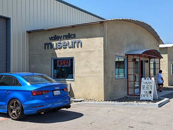 The Valley Relics Museum's modest entrance belies the neon wonderland waiting inside—like finding Las Vegas in your garage.