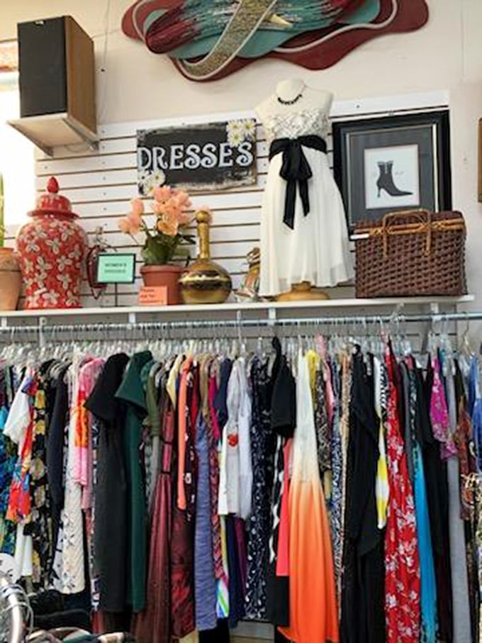 Elegantly displayed vintage dresses and decor items create a curated feel. Thrifting with a touch of class!