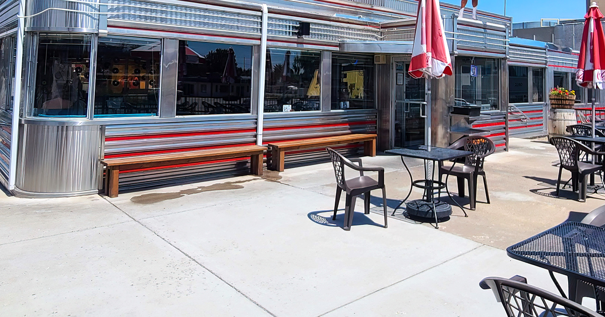 The gleaming chrome exterior of Davies' Chuck Wagon Diner shines like a time machine to the 1950s, complete with those classic horizontal stripes that scream "American optimism."