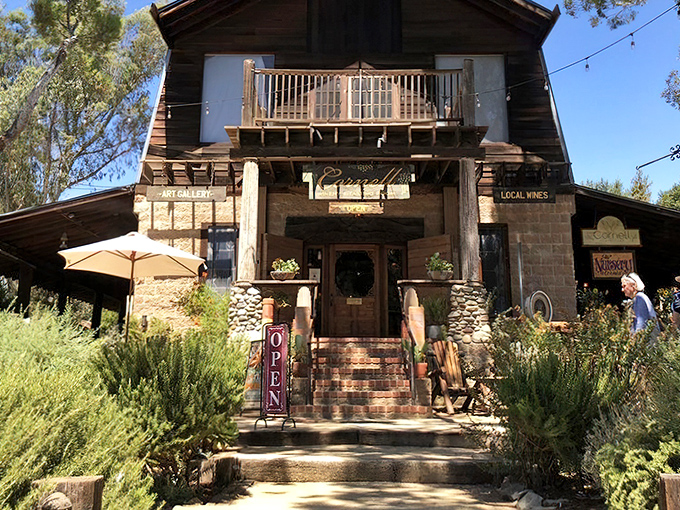 The Old Place stands like a time capsule in Agoura Hills, its weathered wood and stone facade promising culinary adventures that cowboys of yesteryear could only dream about.