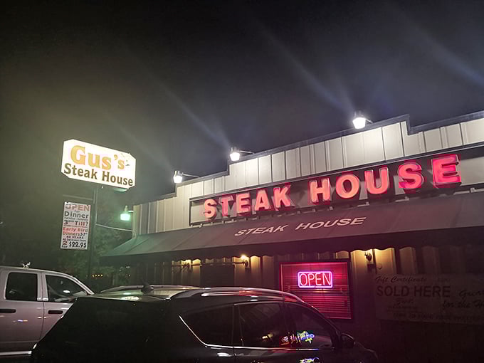 The neon glow of Gus's Steakhouse beckons hungry travelers like a carnivorous lighthouse in the Sierra foothills. Steak salvation awaits inside.