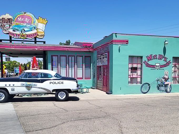 That turquoise and pink exterior isn't just a building—it's a time machine disguised as a diner. Even the local police can't resist stopping by!