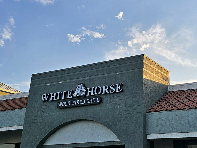 The unassuming exterior of White Horse Wood-Fired Grill proves the old adage: never judge a burger joint by its stucco facade.