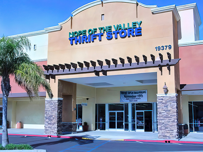 The desert-toned exterior with bright blue signage feels like California's answer to retail therapy—palm trees included, naturally.