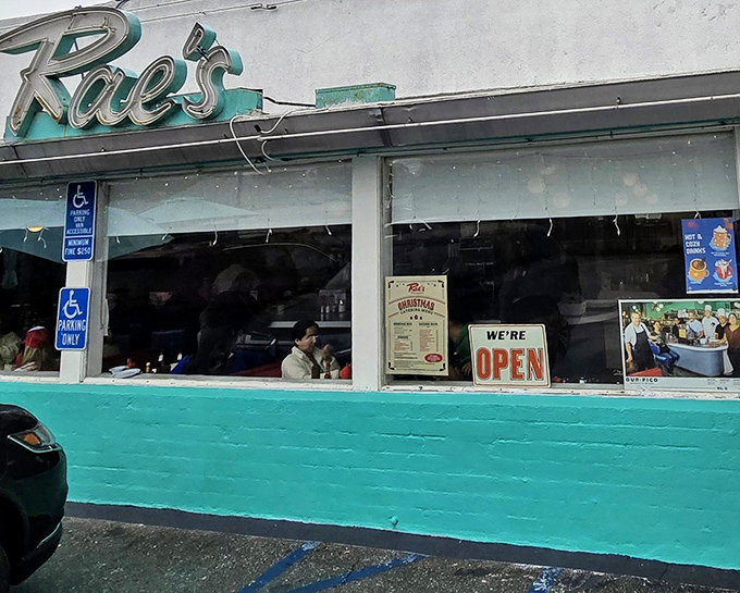 That iconic turquoise exterior isn't just a color choice—it's a time machine disguised as a diner. Welcome to Rae's, where nostalgia comes served with every meal.