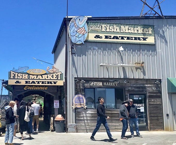 The unassuming exterior of Phil's Fish Market & Eatery stands like a seafood speakeasy – no fancy frills, just the promise of oceanic treasures within those weathered wooden walls.