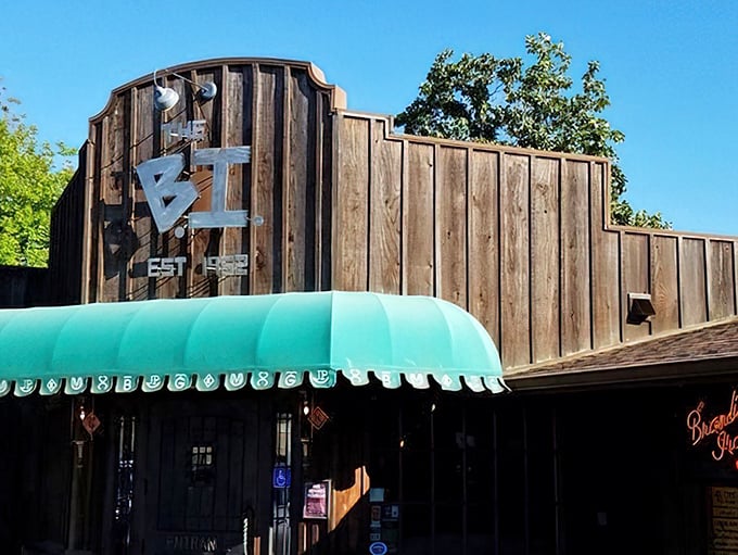 The iconic wooden facade of "The B.I." stands proudly against the California sky, its turquoise awning beckoning hungry travelers like a culinary lighthouse.
