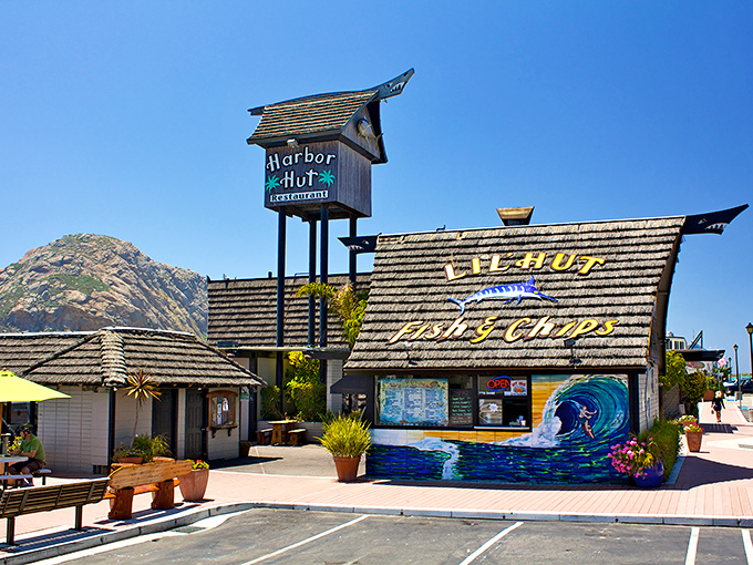The iconic A-frame silhouette of Harbor Hut stands proudly against Morro Rock, like California's answer to a Hawaiian postcard come to life.