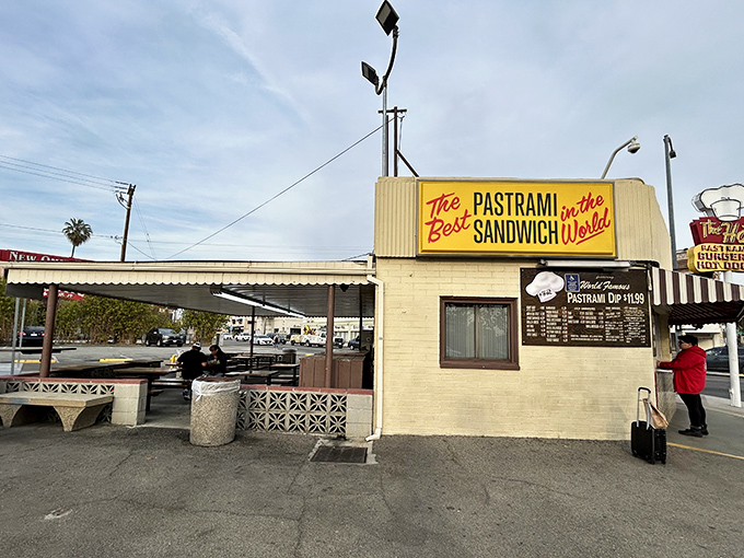 The iconic yellow sign promises "The Best Pastrami Sandwich in the World" – a bold claim The Hat has been backing up for decades.