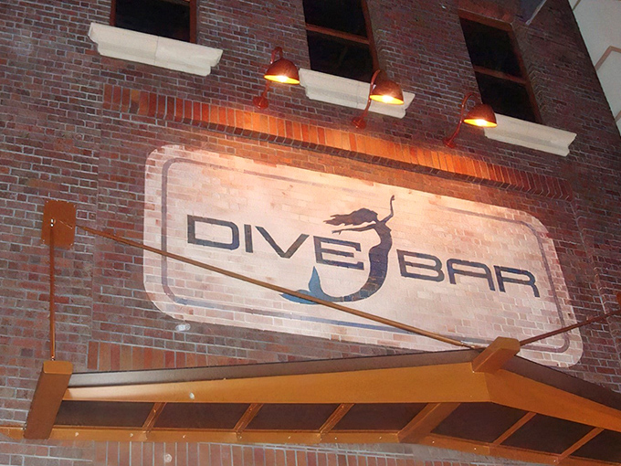 The brick facade of Dive Bar beckons with its illuminated mermaid logo – Sacramento's answer to "what if Ariel opened a cocktail lounge?"