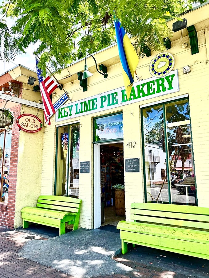 The cheerful yellow facade of Key Lime Republic welcomes visitors with bright green benches that practically scream "sit here after pie consumption!"
