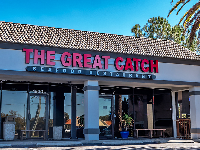 The Great Catch's bold red signage stands out like a lighthouse beacon for seafood lovers, promising New England treasures in sunny Florida.