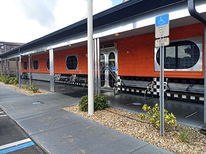 The bright orange exterior with porthole windows isn't just eye-catching—it's a time portal to the 1950s waiting in Haines City. No DeLorean required.
