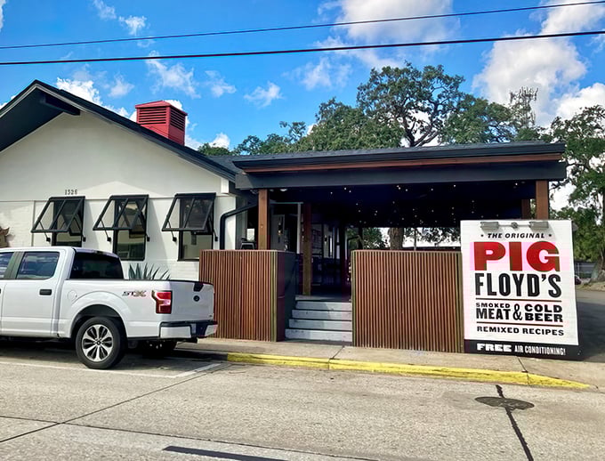 The inviting patio at Pig Floyd's welcomes barbecue pilgrims with playful pig artwork and comfortable outdoor seating—a carnivore's sanctuary in Orlando's Mills 50 district.