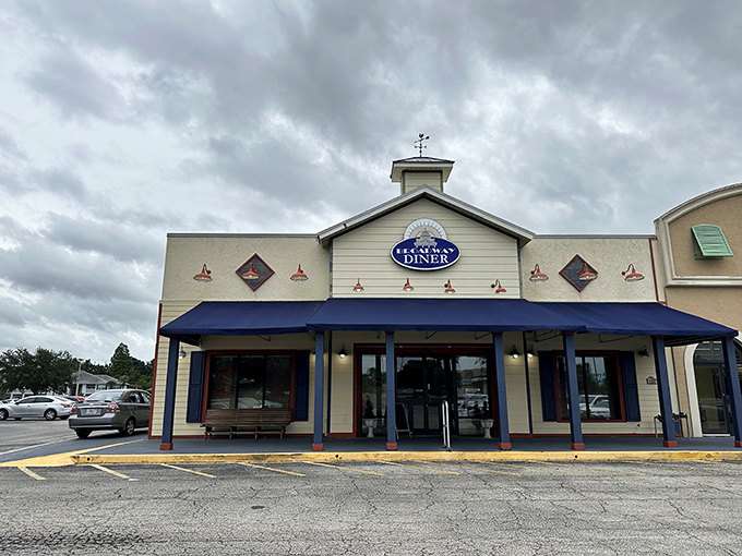 The welcoming facade of Broadway Diner in Bartow beckons with its classic blue awning and warm lighting—like a culinary lighthouse for hungry travelers.