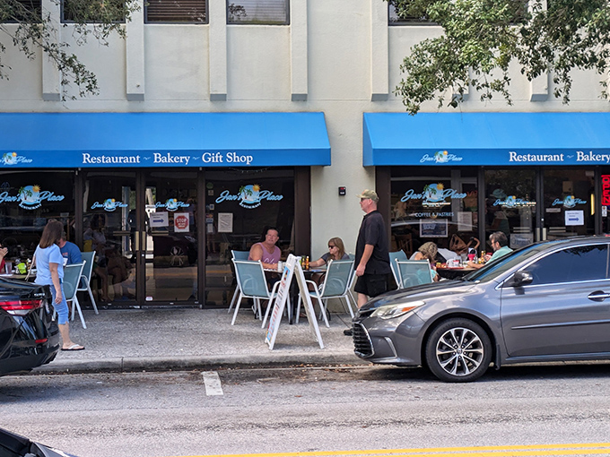 The bright blue awning of Jan's Place beckons like a breakfast lighthouse amid Jensen Beach's morning bustle. Outdoor seating for the brave Florida summer warriors.