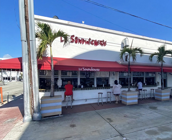 The unassuming storefront with its signature red awning proves that culinary greatness doesn't need flashy neon or velvet ropes—just perfect sandwiches and hungry customers.