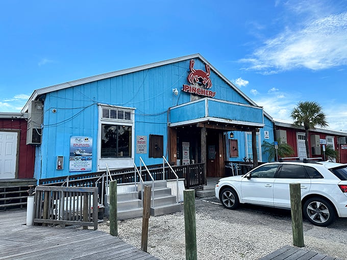 Pinchers' cheerful blue exterior beckons seafood lovers like a coastal lighthouse, promising treasures from the deep just steps from the water.