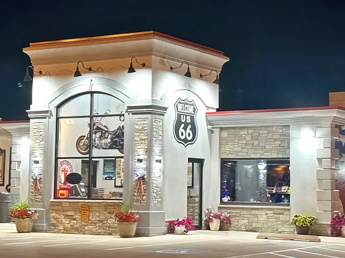 The gleaming white stone façade glows like a beacon in the night, promising weary travelers the holy trinity of road food: coffee, pie, and nostalgia.