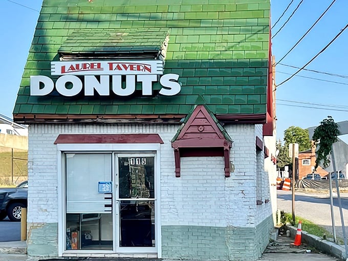 The iconic green-shingled roof and weathered "DONUTS HAMBURGERS" sign announce this Laurel institution without fanfare—architectural honesty at its most delicious.