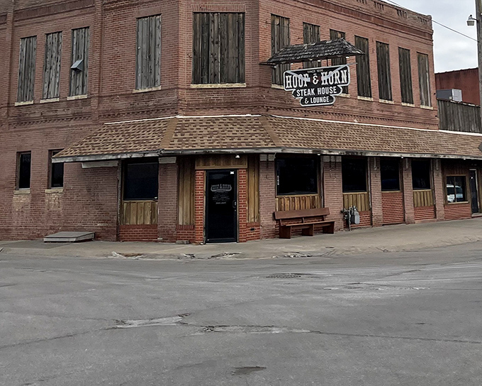 The historic brick exterior of Hoof & Horn stands like a time capsule at a crossroads, promising carnivorous delights within its weathered walls.