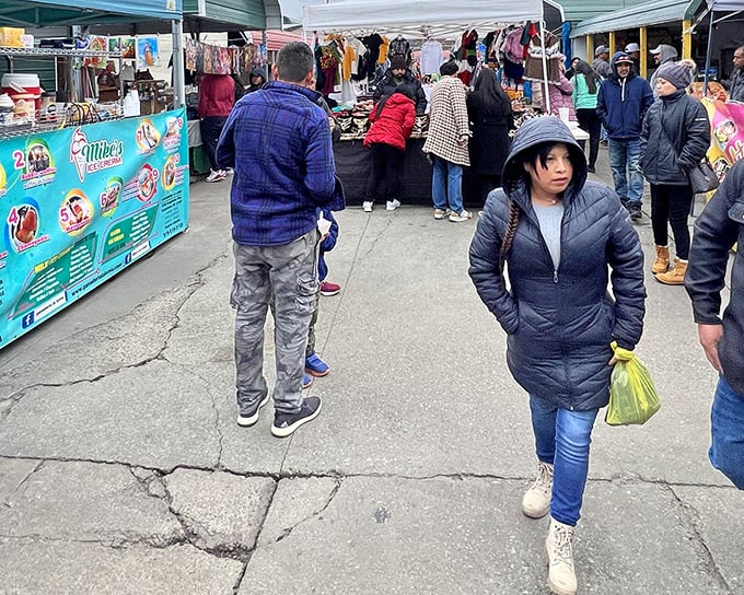 Glass display cases become treasure chests at Durham Green Flea Market, where shoppers hunt for collectibles while colorful piñatas stand guard overhead.
