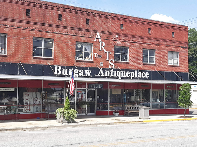 The iconic red brick façade of Burgaw Antique Place stands as a time portal in downtown Burgaw, inviting curious souls to step back through the decades.