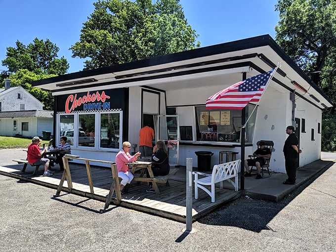 The classic black-and-white checkered pattern isn't just decoration—it's a beacon calling hungry travelers to this slice of Americana in Perry.