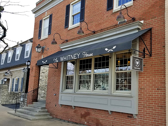 The brick façade of The Whitney House exudes small-town charm with big-city culinary ambitions. Like finding a Michelin-worthy restaurant hiding in plain sight.