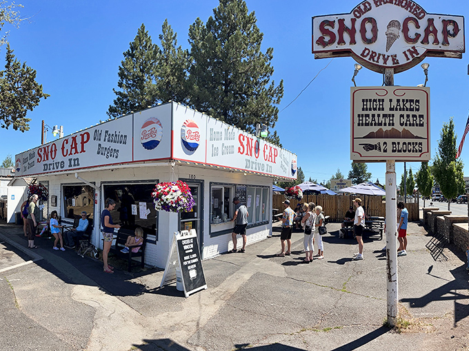 The classic white facade of Sno Cap Drive In stands like a time capsule in Sisters, Oregon, promising homemade ice cream and old-fashioned burgers that deliver on every nostalgic bite.