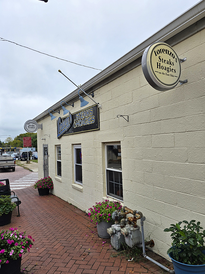 The unassuming white building with festive pennants might not look like food paradise, but locals know better. Sandwich nirvana awaits behind that blue neon sign.