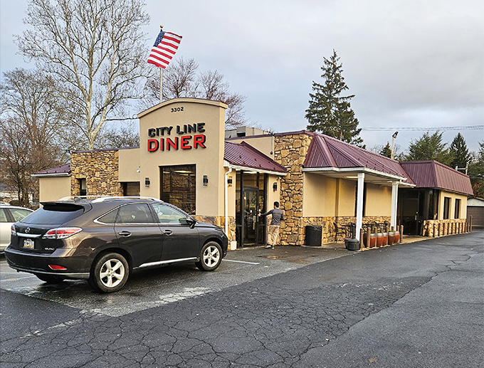 Stone facade, American flag, and that iconic red sign – City Line Diner stands like a delicious fortress of comfort food in Harrisburg.