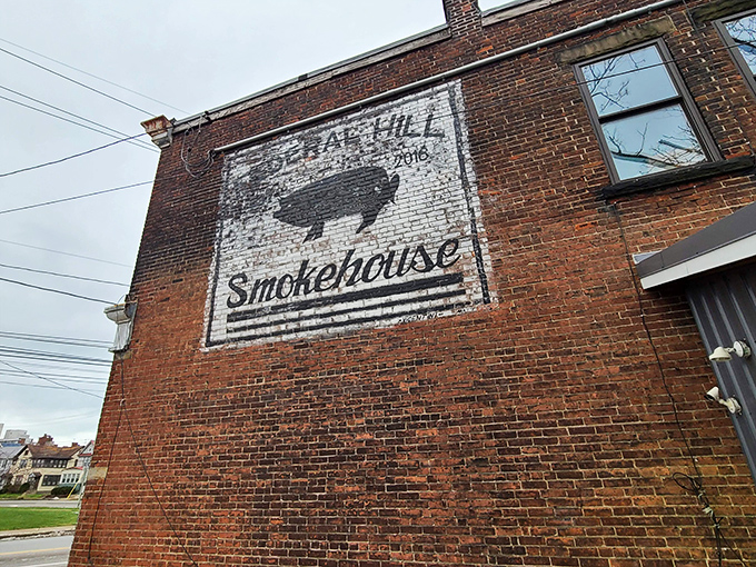 The writing's on the wall—literally! Federal Hill Smokehouse's rustic brick exterior proudly displays its mission with a simple pig silhouette that promises smoky delights within.
