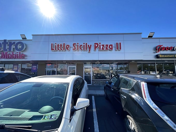 The bright red sign of Little Sicily Pizza 2 beckons like a lighthouse for the hungry. Philadelphia's culinary odd couple – Italian tradition meets Indian spice – hiding in plain sight.