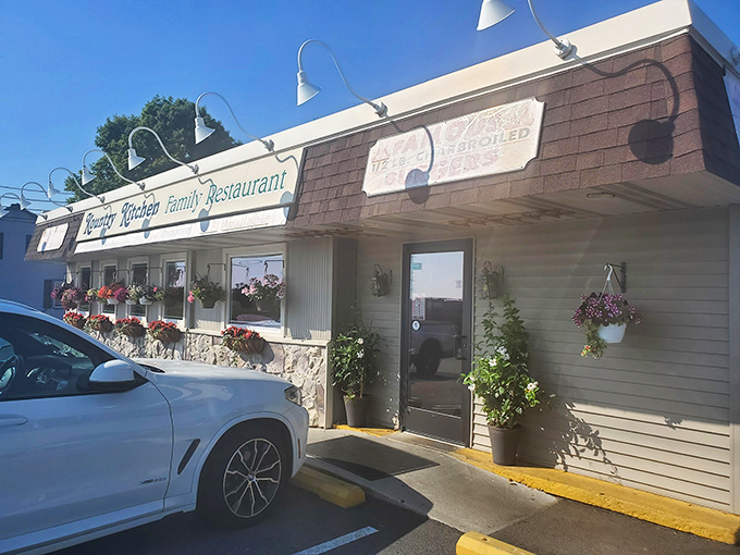 The unassuming exterior of Kountry Kitchen belies the culinary treasures within. Those hanging flower baskets aren't just for show—they're your first clue this place cares about the details.