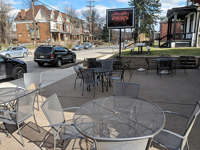 The unassuming brick exterior of Showcase BBQ belies the culinary treasures within. Those patio tables have witnessed countless barbecue epiphanies.