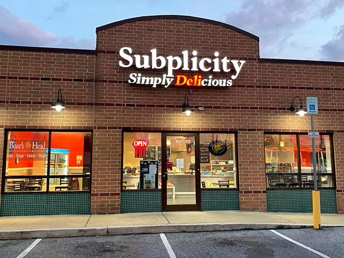 The brick facade of Subplicity stands like a sandwich sanctuary in Breezewood, promising "Simply Delicious" experiences for hungry travelers seeking refuge from turnpike tedium.