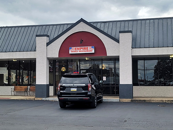 The iconic red arch of Empire Family Restaurant beckons hungry travelers like a culinary lighthouse in a sea of chain restaurants.