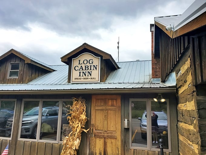 The Log Cabin Inn's weathered wooden exterior isn't just rustic charm—it's a promise of culinary treasures hiding behind that unassuming frontier facade.