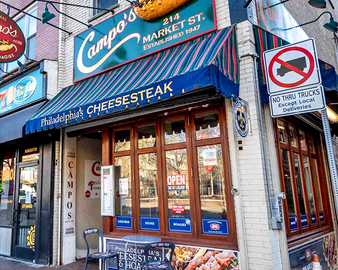 Campo's iconic storefront beckons with its giant cheesesteak sign – like a meaty lighthouse guiding hungry souls through Philadelphia's historic streets.