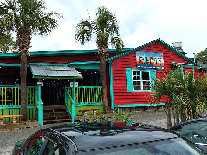 The beach shack of your burger dreams! Vibrant turquoise railings, palm trees, and that iconic red phone booth scream "vacation mode activated."
