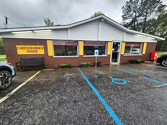 The yellow sign says it all – this unassuming brick building houses burger magic that locals have treasured for decades.
